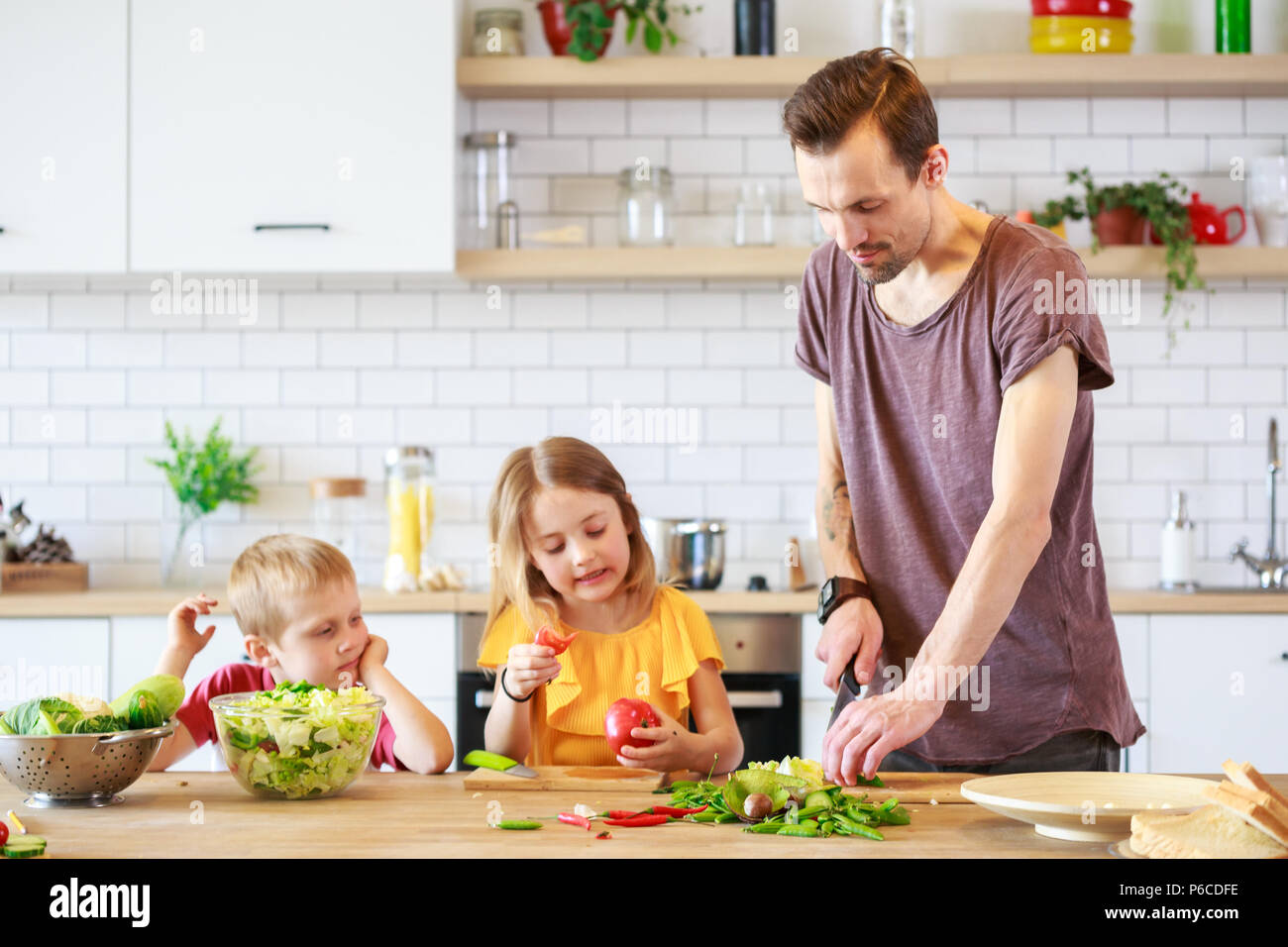 Image of young father with daughter cooking vegetables Stock Photo - Alamy