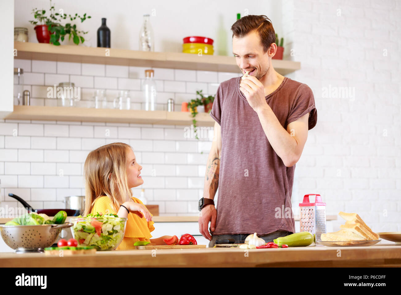 Picture of young father with daughter cooking lunch Stock Photo - Alamy