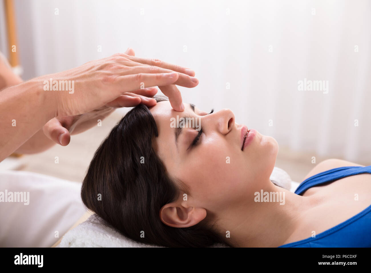 Woman receiving reiki treatment hi-res stock photography and images - Alamy