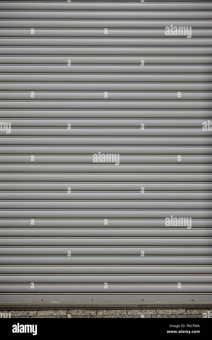 Metal roller shutter door of store closed Stock Photo - Alamy
