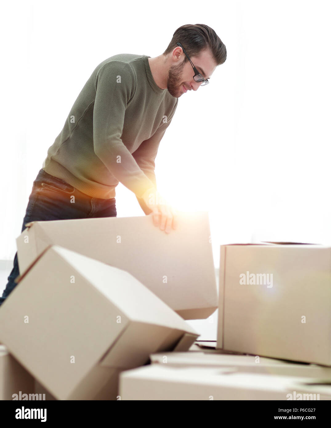 confident man unpacking boxes in the new house Stock Photo - Alamy