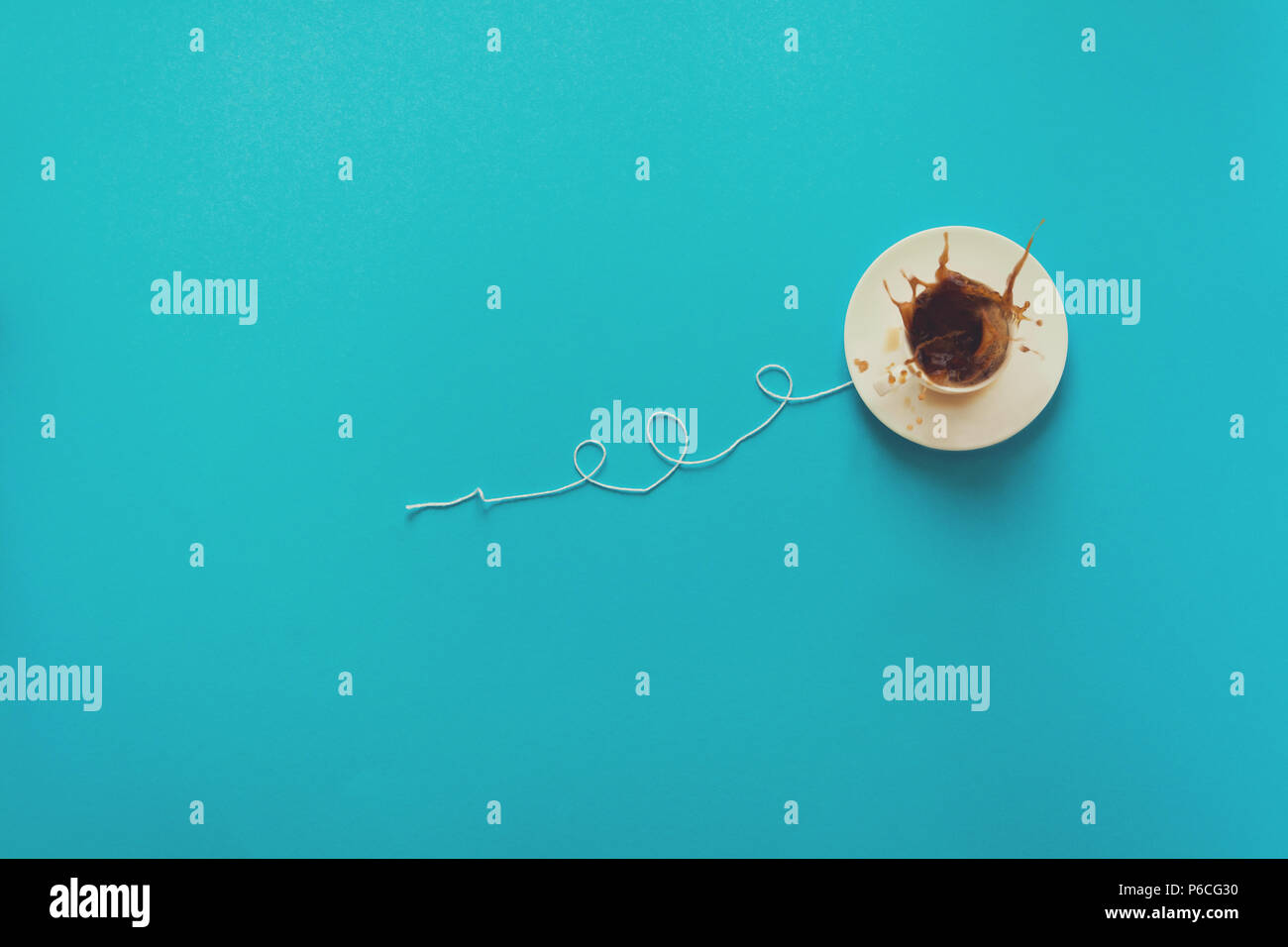 Coffee cup in shape of balloon with cllouds on blue paper background ...