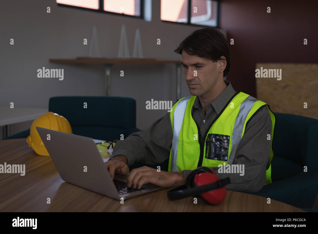 Male worker using laptop at desk Stock Photo - Alamy