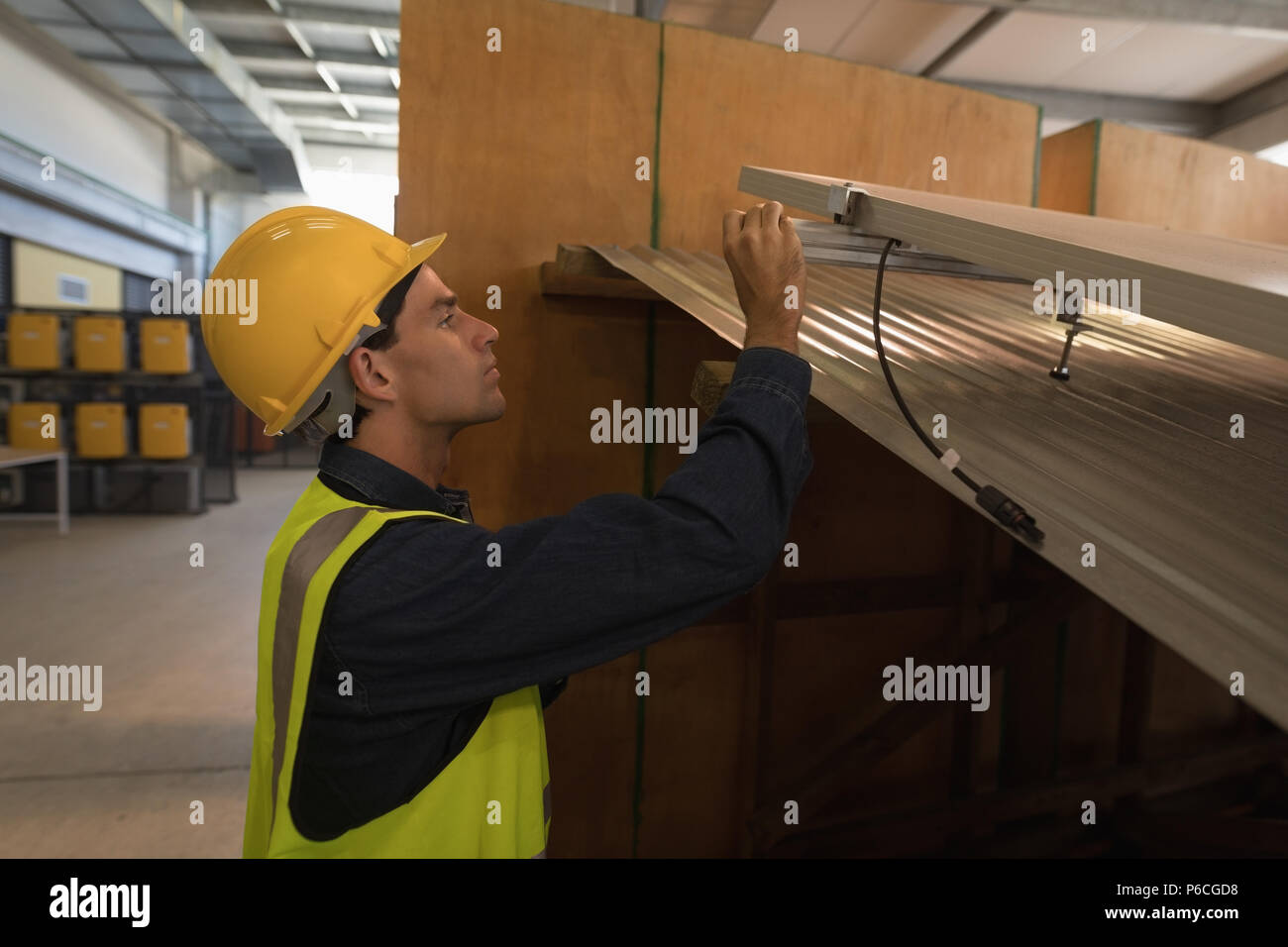 Male worker working on solar panel Stock Photo - Alamy