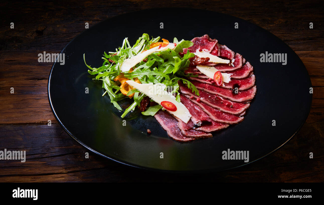 Barbecue wagyu roast beef sliced as top view on a metal tray with copy ...