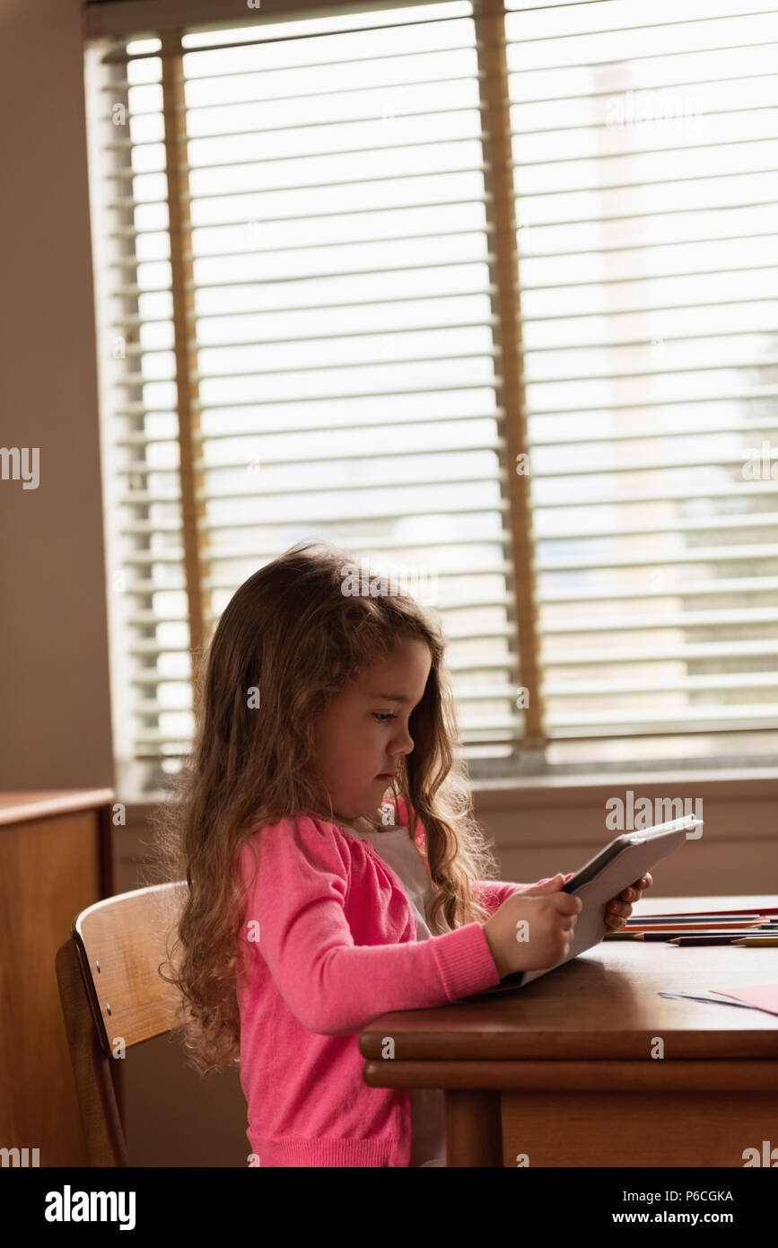 Cute girl sitting table using hi-res stock photography and images - Alamy