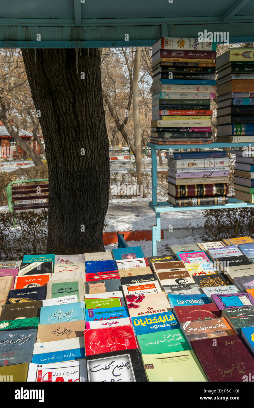 Colourful and neatly stacked books in written in the Persian Farsi ...
