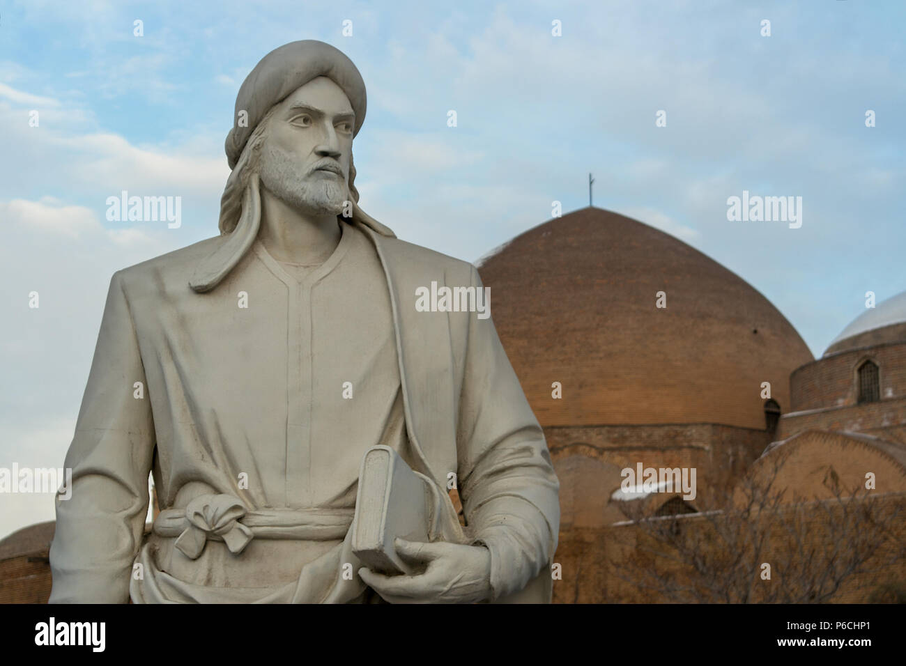 Statue of Iranian poet Khaqani with the Blue Mosque of Tabriz, Iran in ...