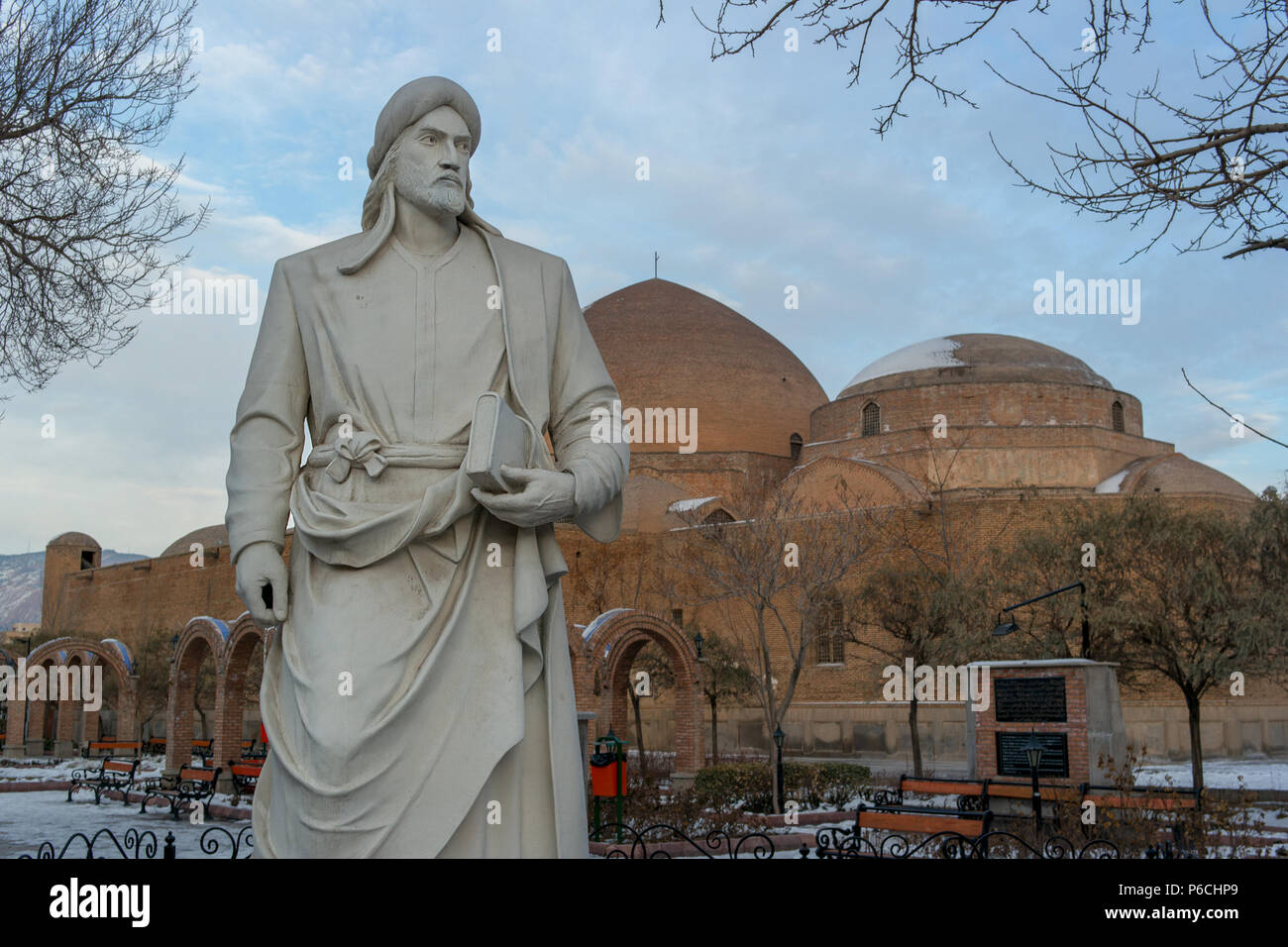 Statue of Iranian poet Khaqani with the Blue Mosque of Tabriz, Iran in ...