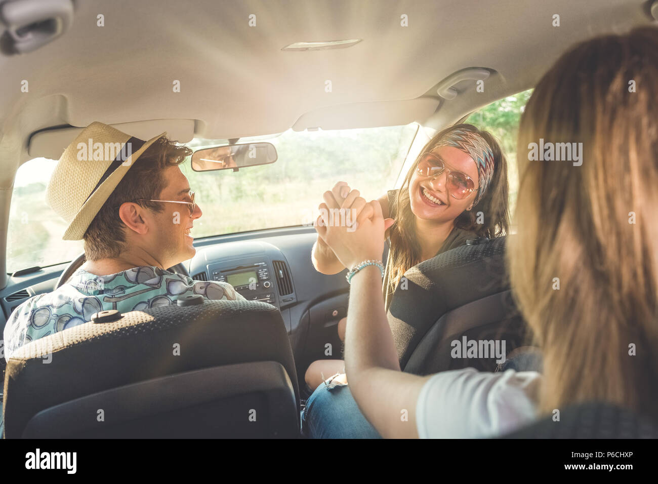 Group of friends enjoying road trip in their car Stock Photo - Alamy