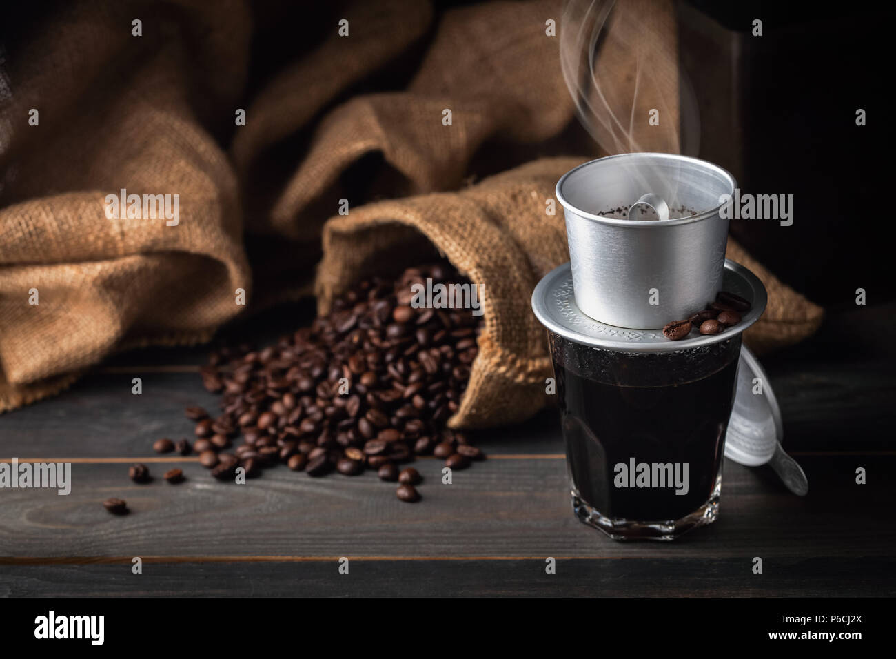 Vintage vietnam coffee dripper, coffee cup and coffee beans with bag ...