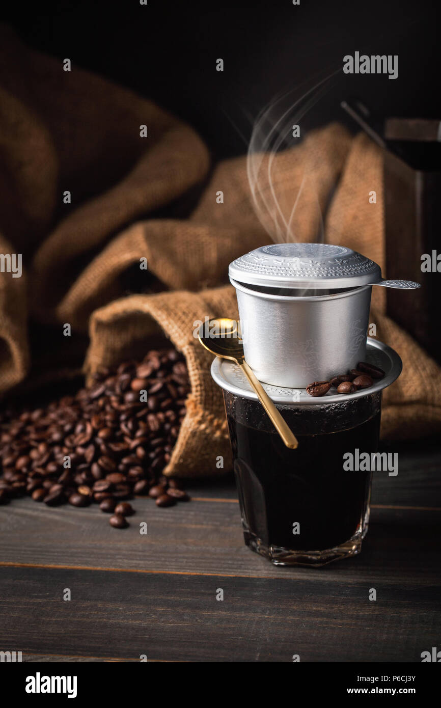 Vintage vietnam coffee dripper, coffee cup and coffee beans with bag ...