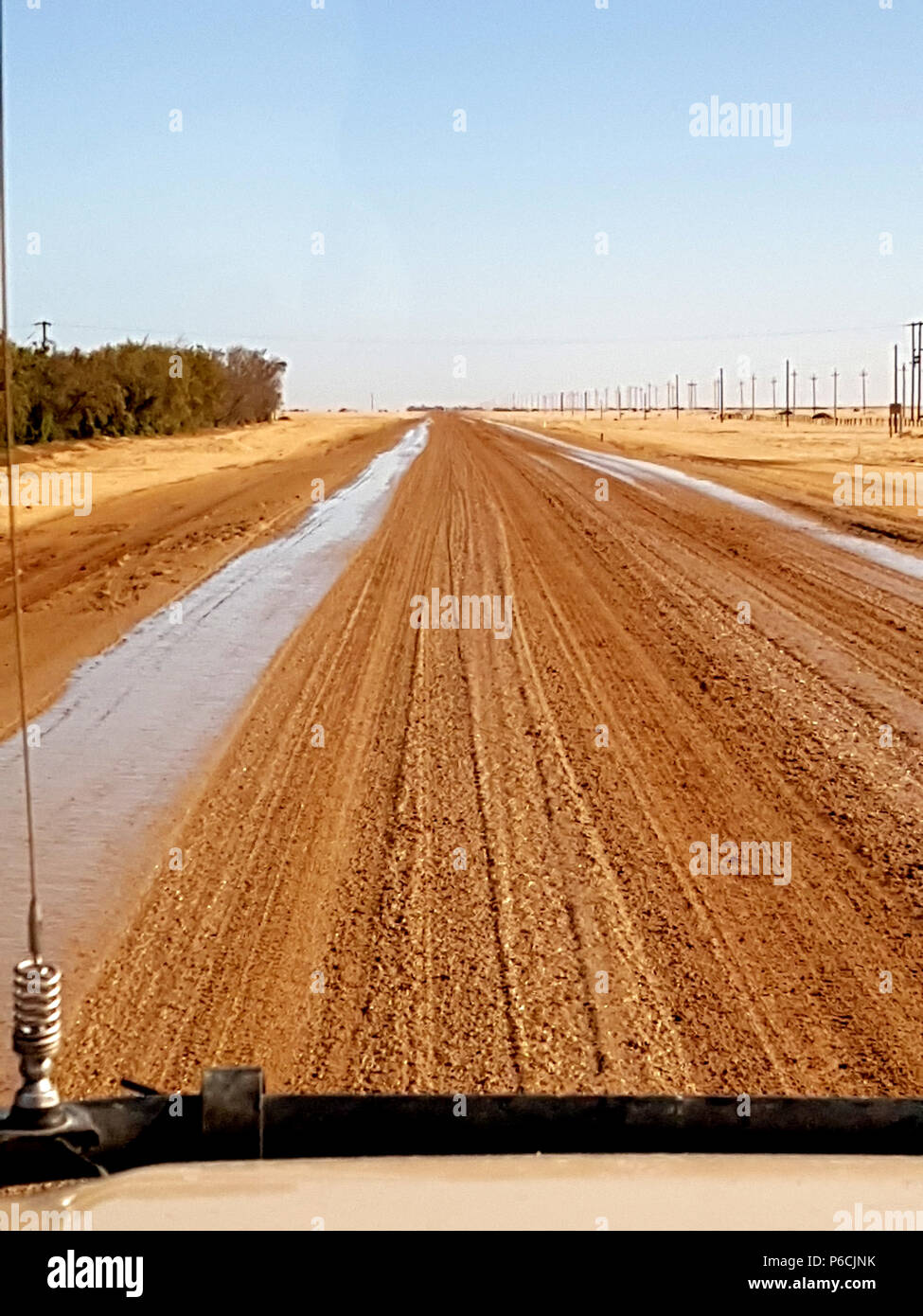 Muddy Namibian road and upturned car after heavy rain Stock Photo - Alamy