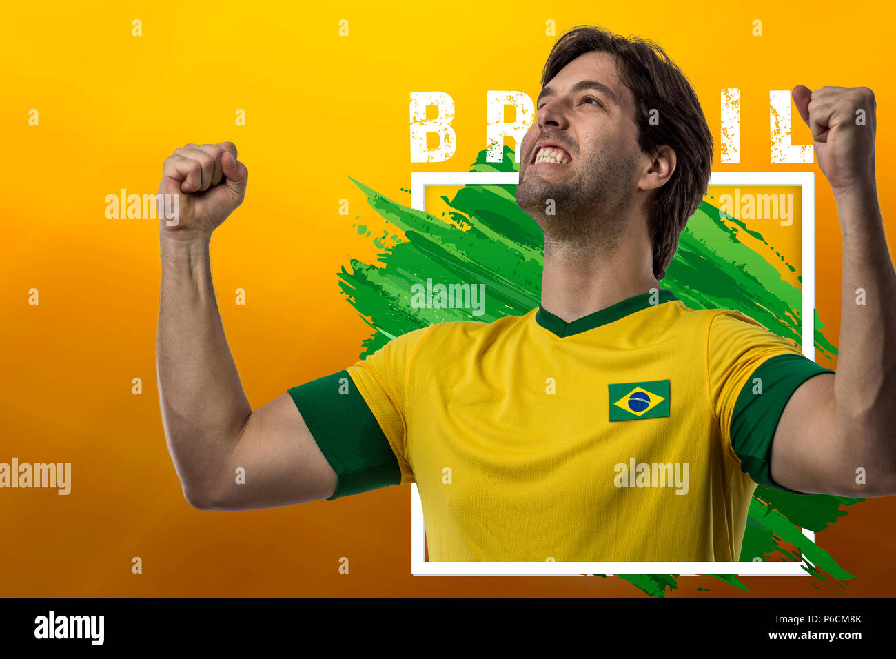 Brazilian soccer player, celebrating on a yellow background with copy ...