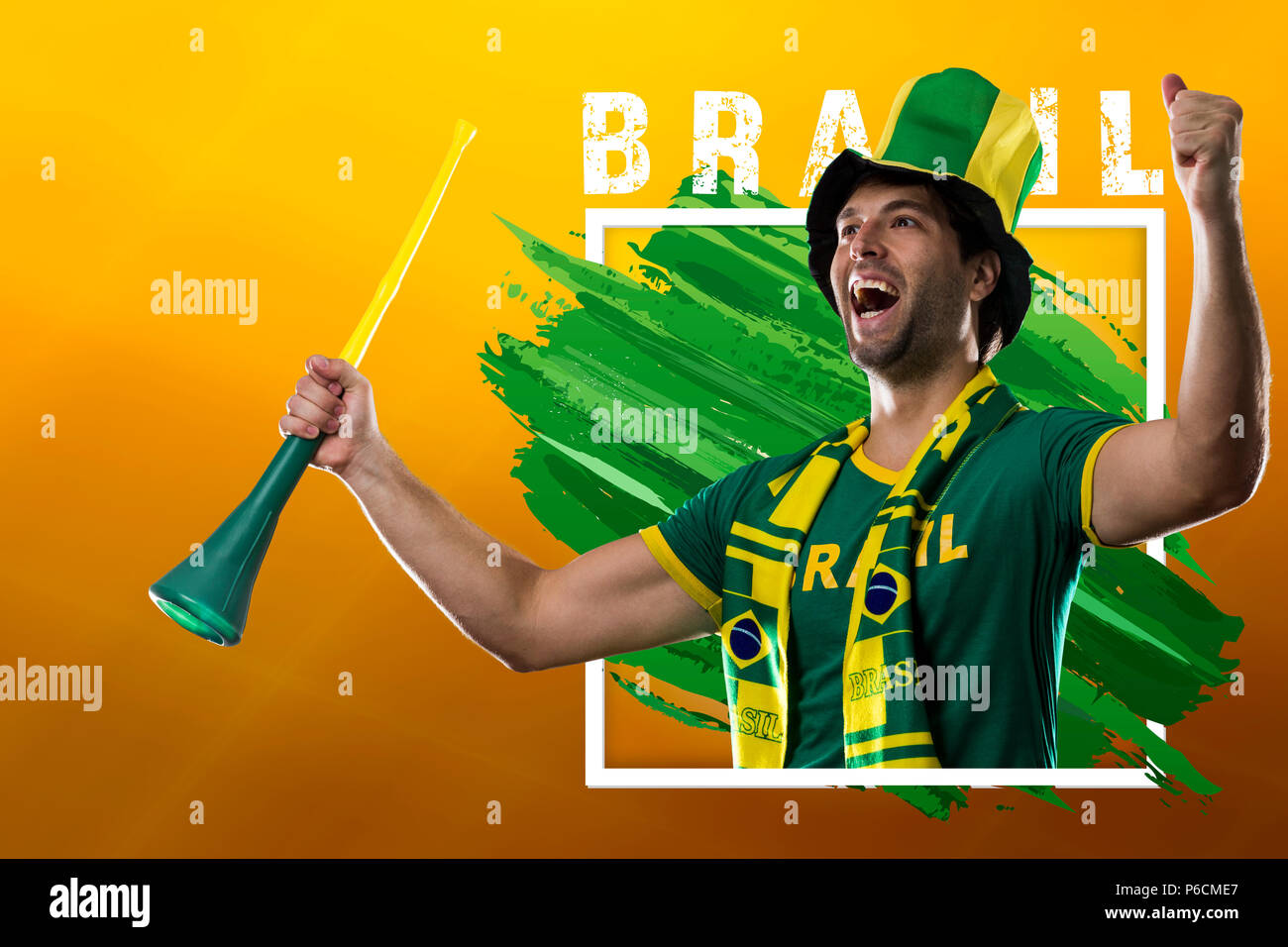 Brazilian male fan, celebrating on a yellow background with copy space ...