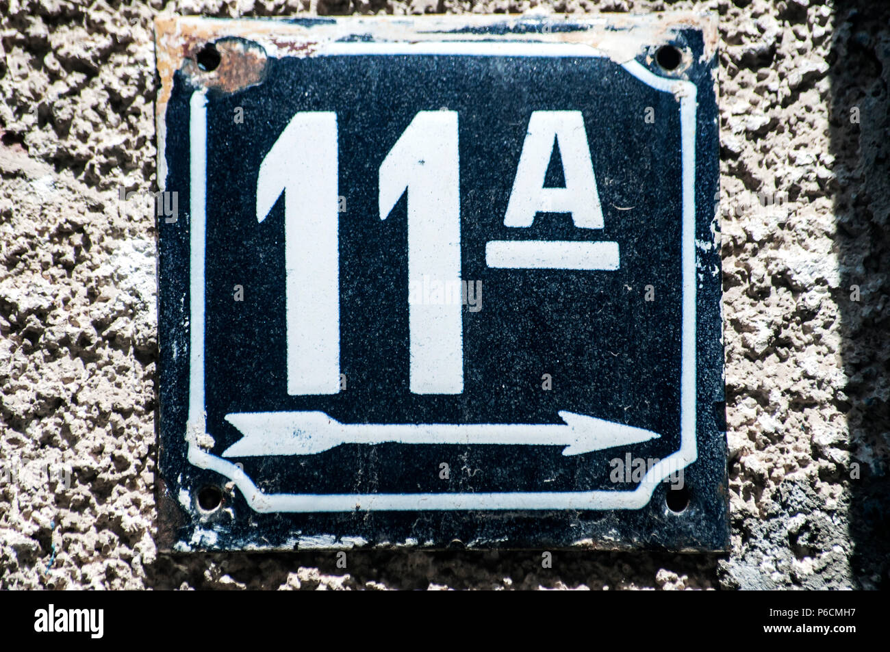 Weathered grunge square metal enameled plate of number of street ...