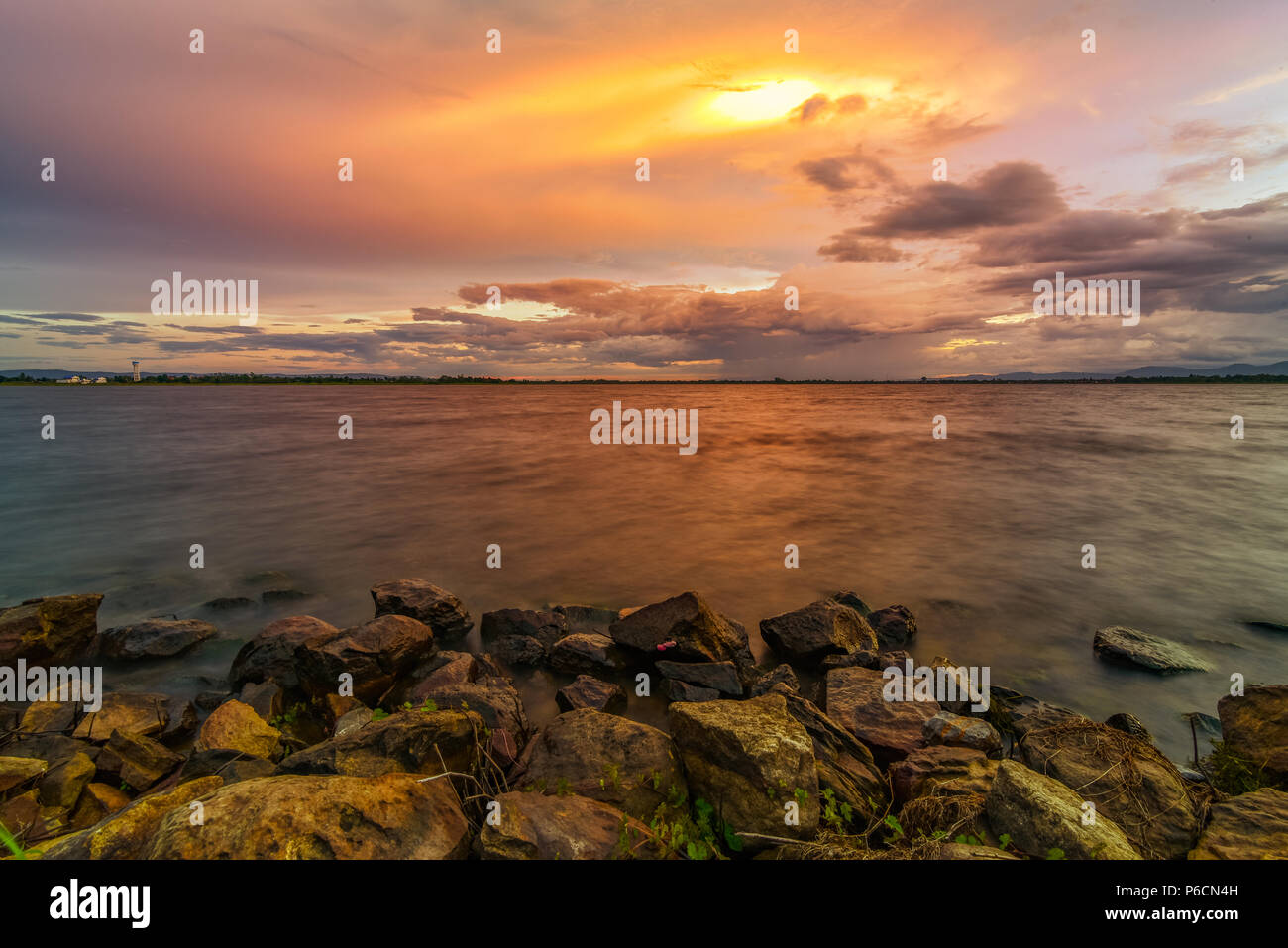 Landscape small lake with sunset with stone at foreground Stock Photo ...
