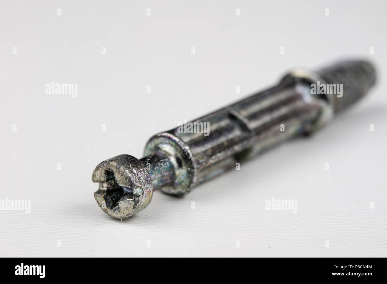 Screw head on a white table. Accessories for screw connections. Light ...