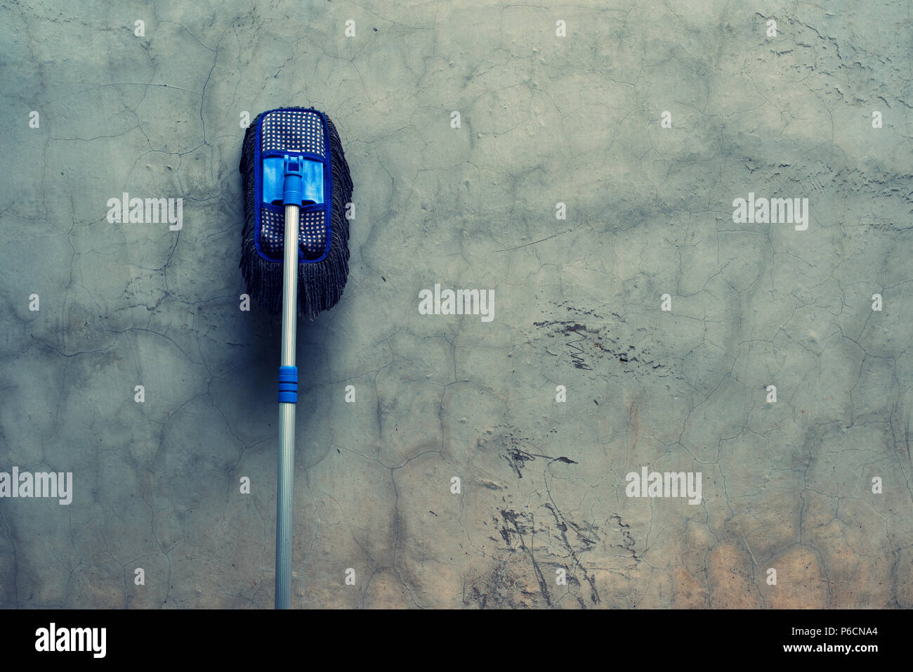 mop holding on wall Stock Photo - Alamy