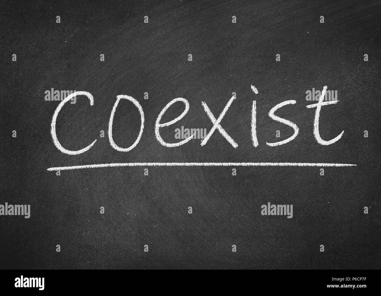 coexist concept word on a blackboard background Stock Photo - Alamy