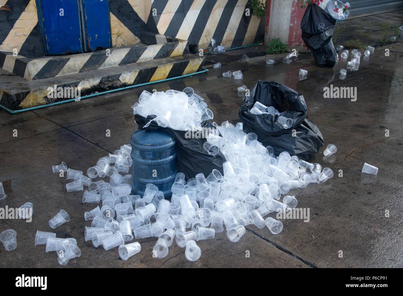 Recyclable garbage of plastic glass in rubbish bin and floor Stock ...