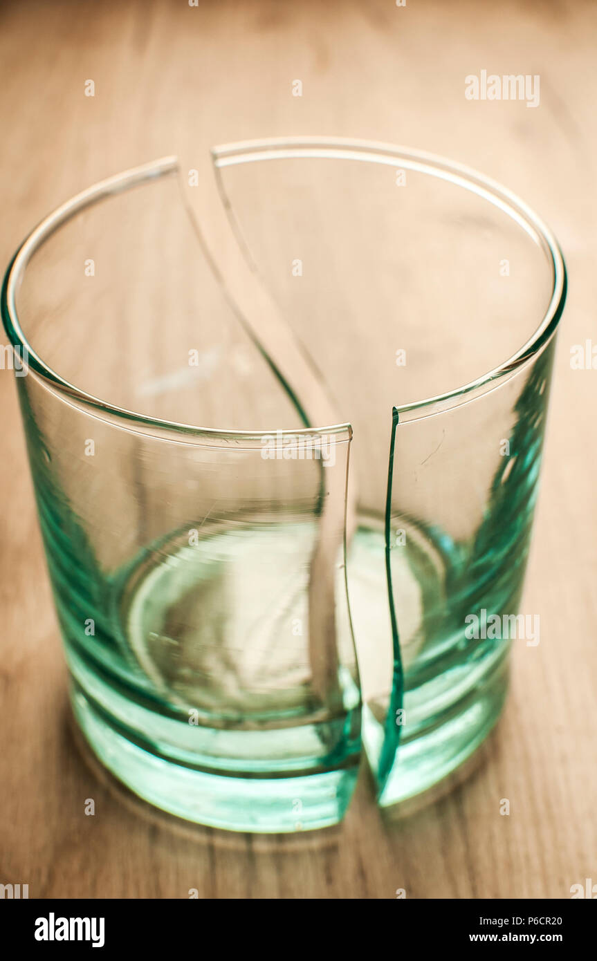 Broken transparent glass cup in two symmetrical parts closeup Stock ...