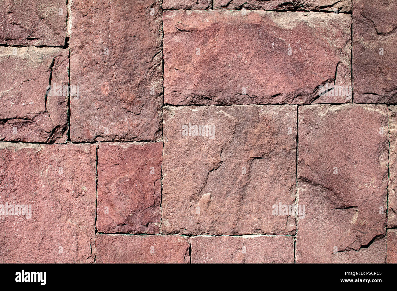 House wall decorative facing slabs of red sandstone closeup as ...