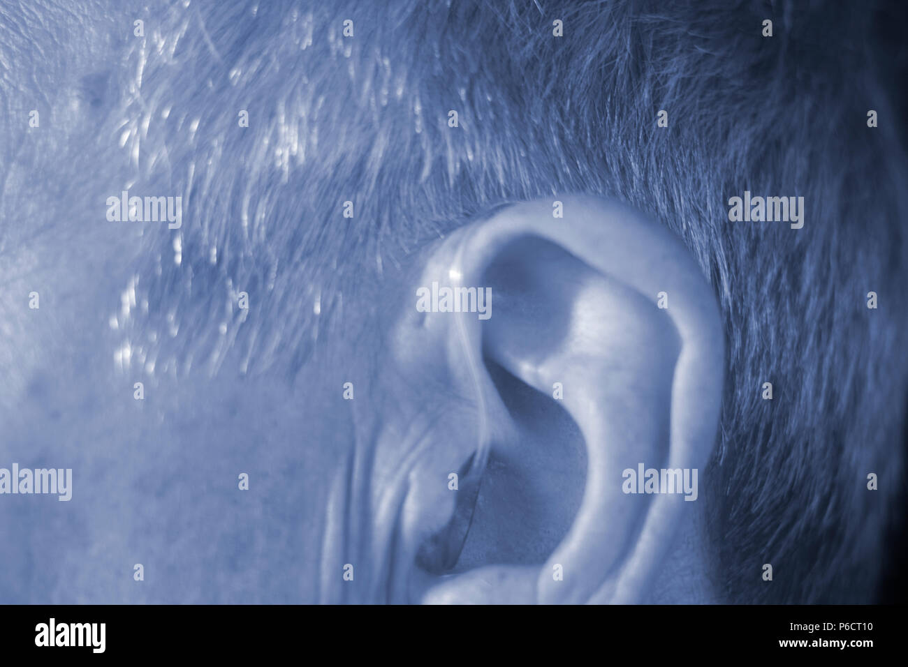 Deaf senior citizen man wearing modern digital high technology hearing ...