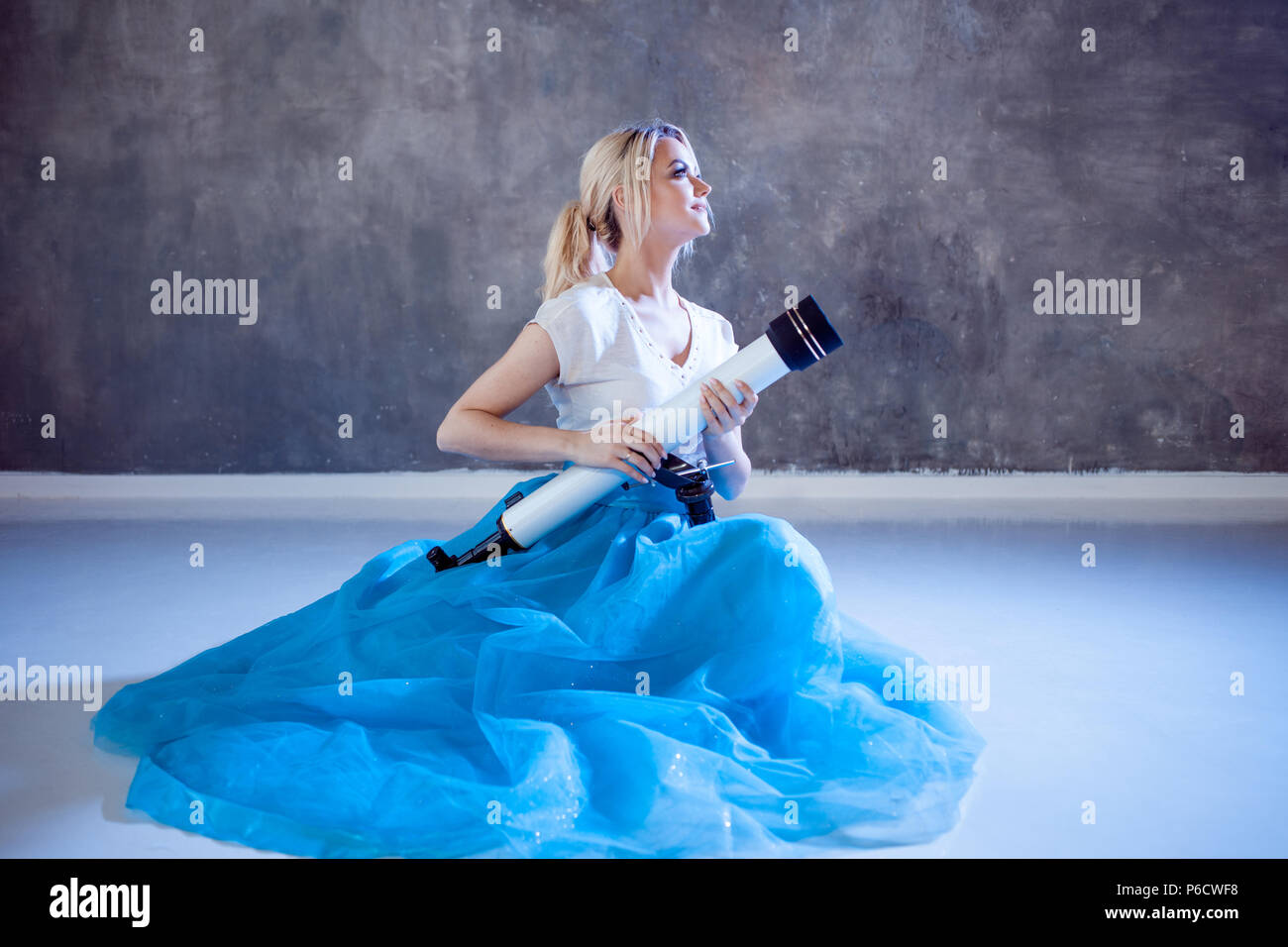 Young woman dreams of the future, concept. Girl looks up and uses a ...