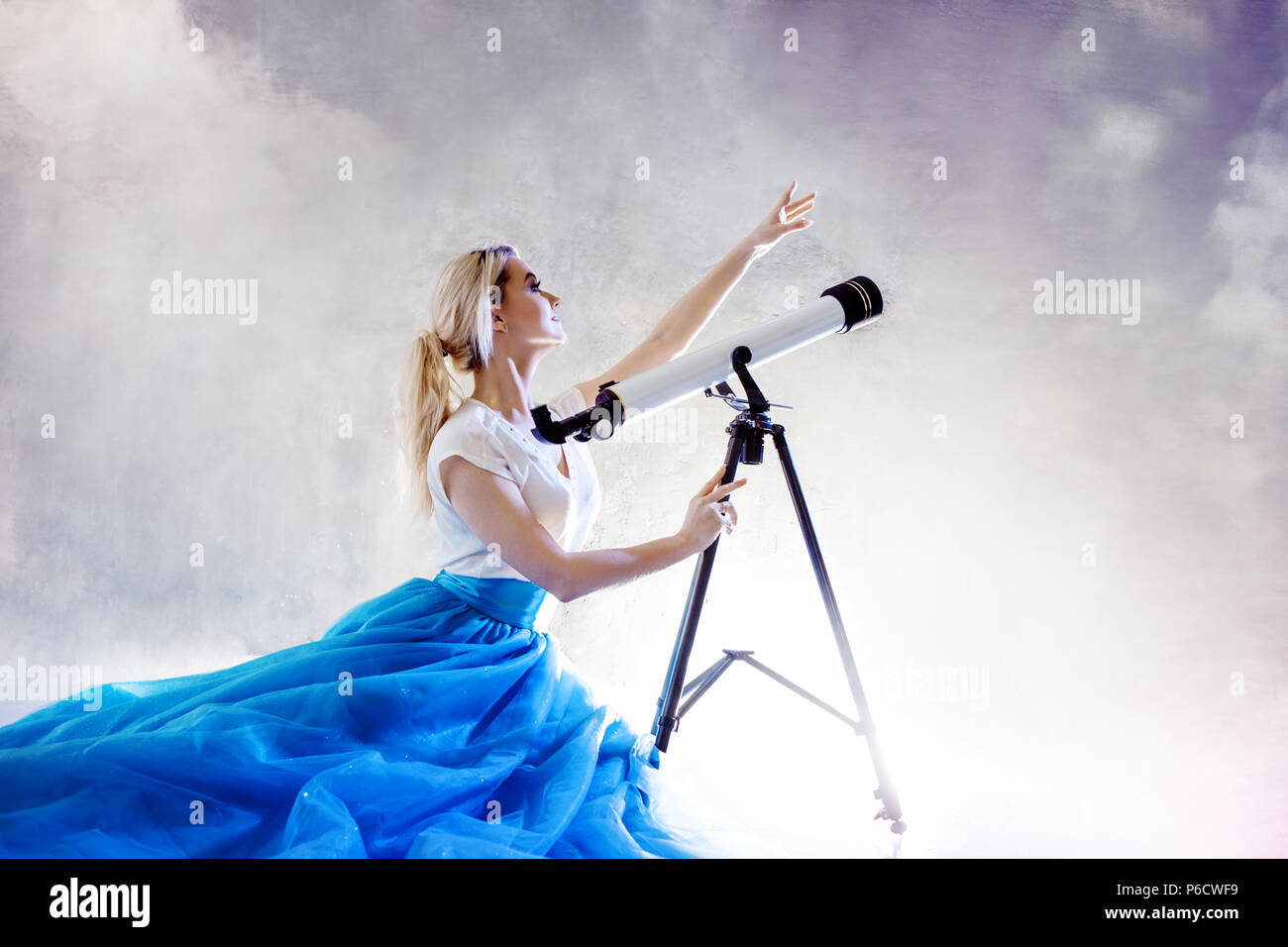 Young woman dreams of the future, concept. Girl in the sky with clouds ...