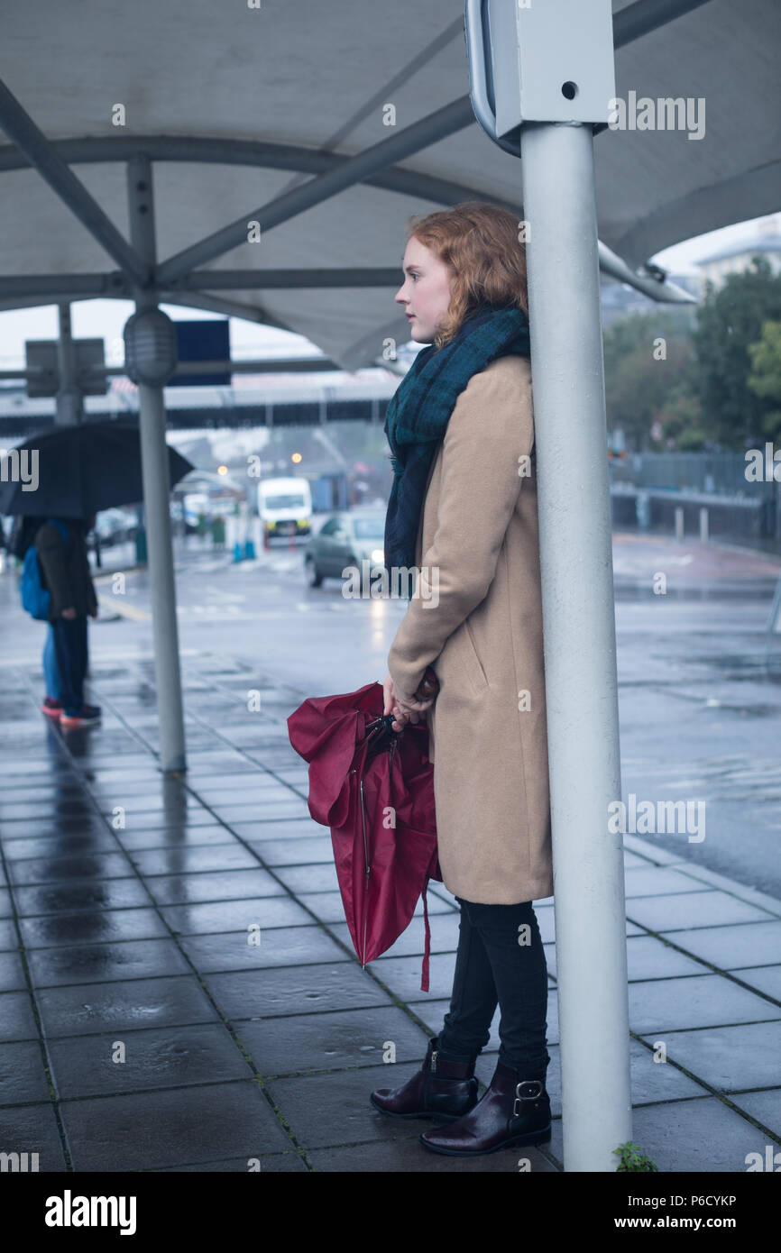 Woman standing bus stop hi-res stock photography and images - Alamy