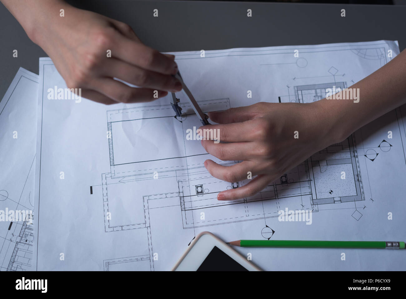 Female executive working on blueprint in office Stock Photo - Alamy