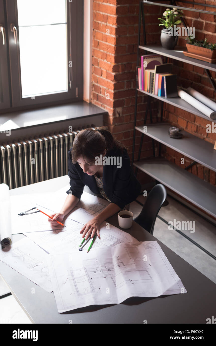 Female executive working on blueprint Stock Photo - Alamy