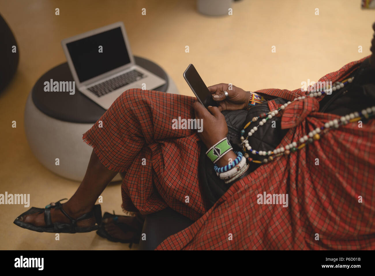 Maasai man in traditional clothing using mobile phone Stock Photo - Alamy