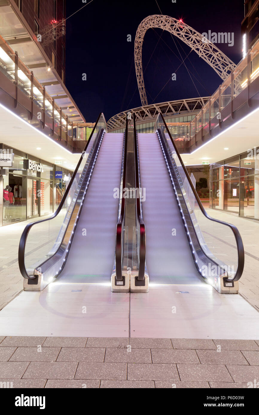 Escalators at Wembley Shopping centre with Stadium in the background ...