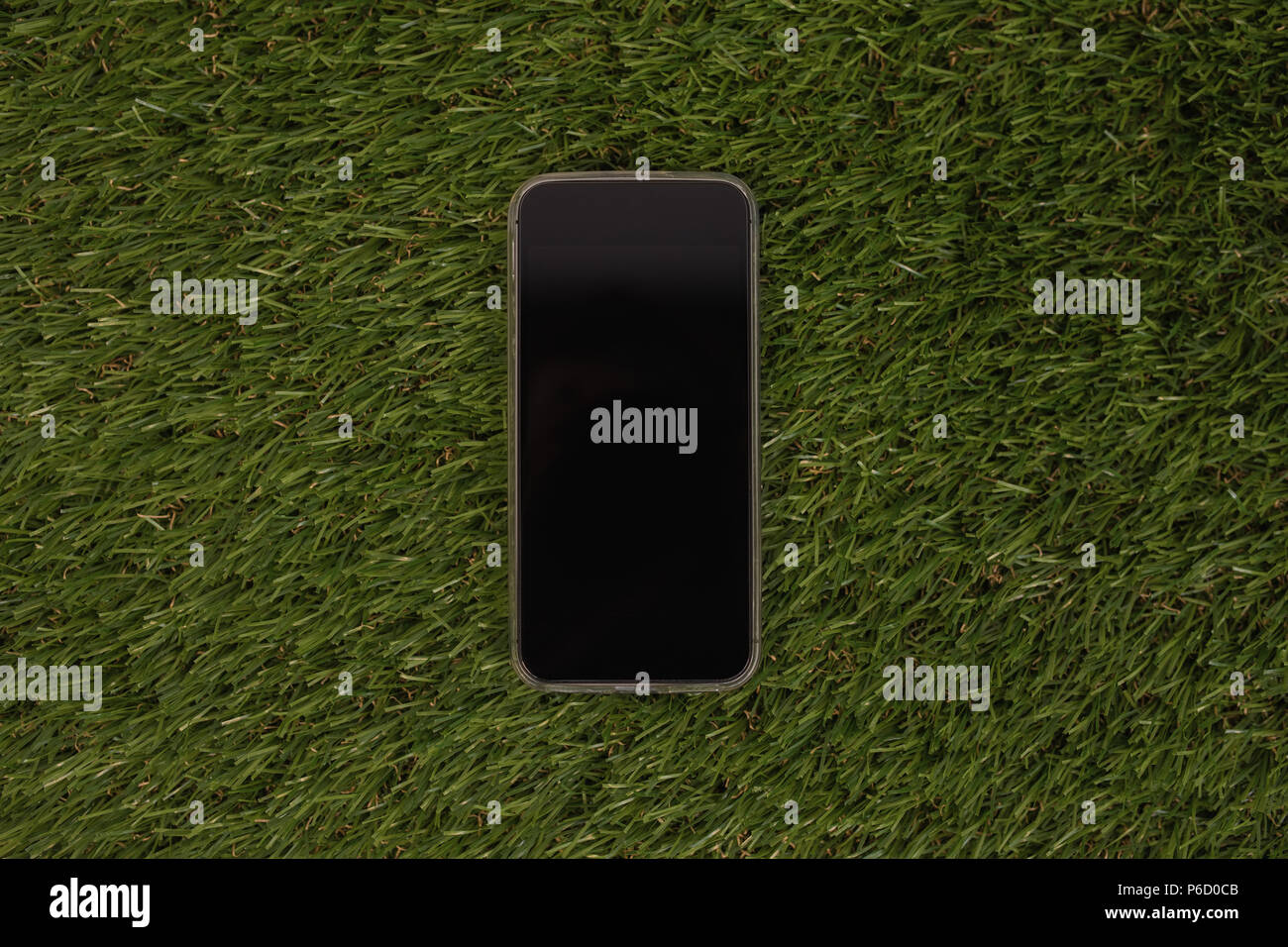 Mobile phone of artificial grass Stock Photo - Alamy
