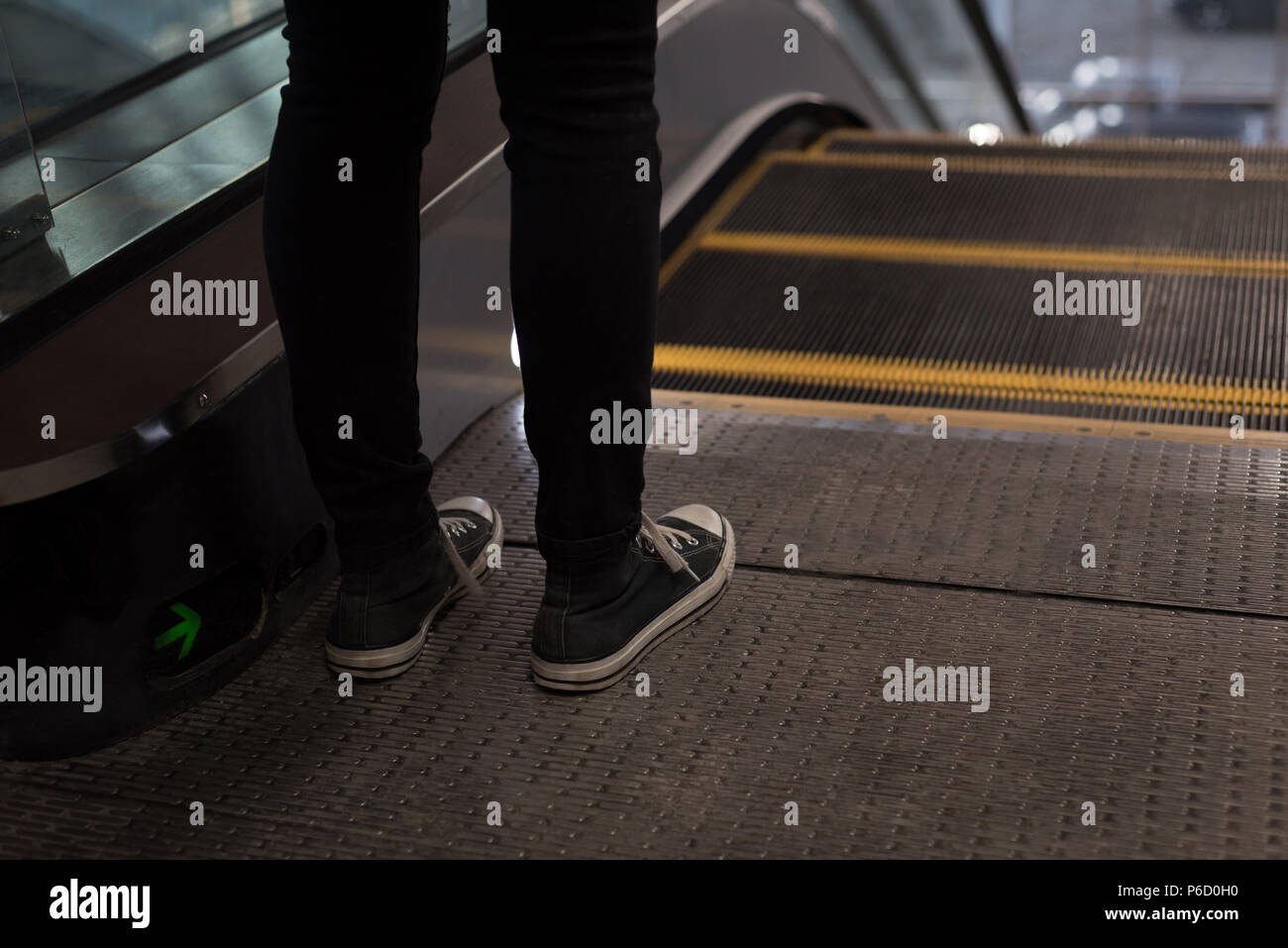 Female escalator commuter hi-res stock photography and images - Alamy