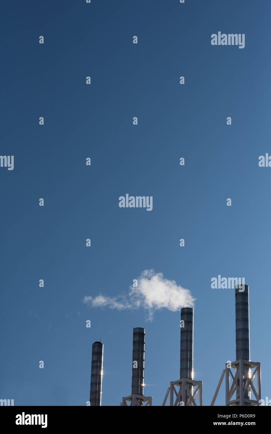 Smoke coming out of factory chimney Stock Photo - Alamy