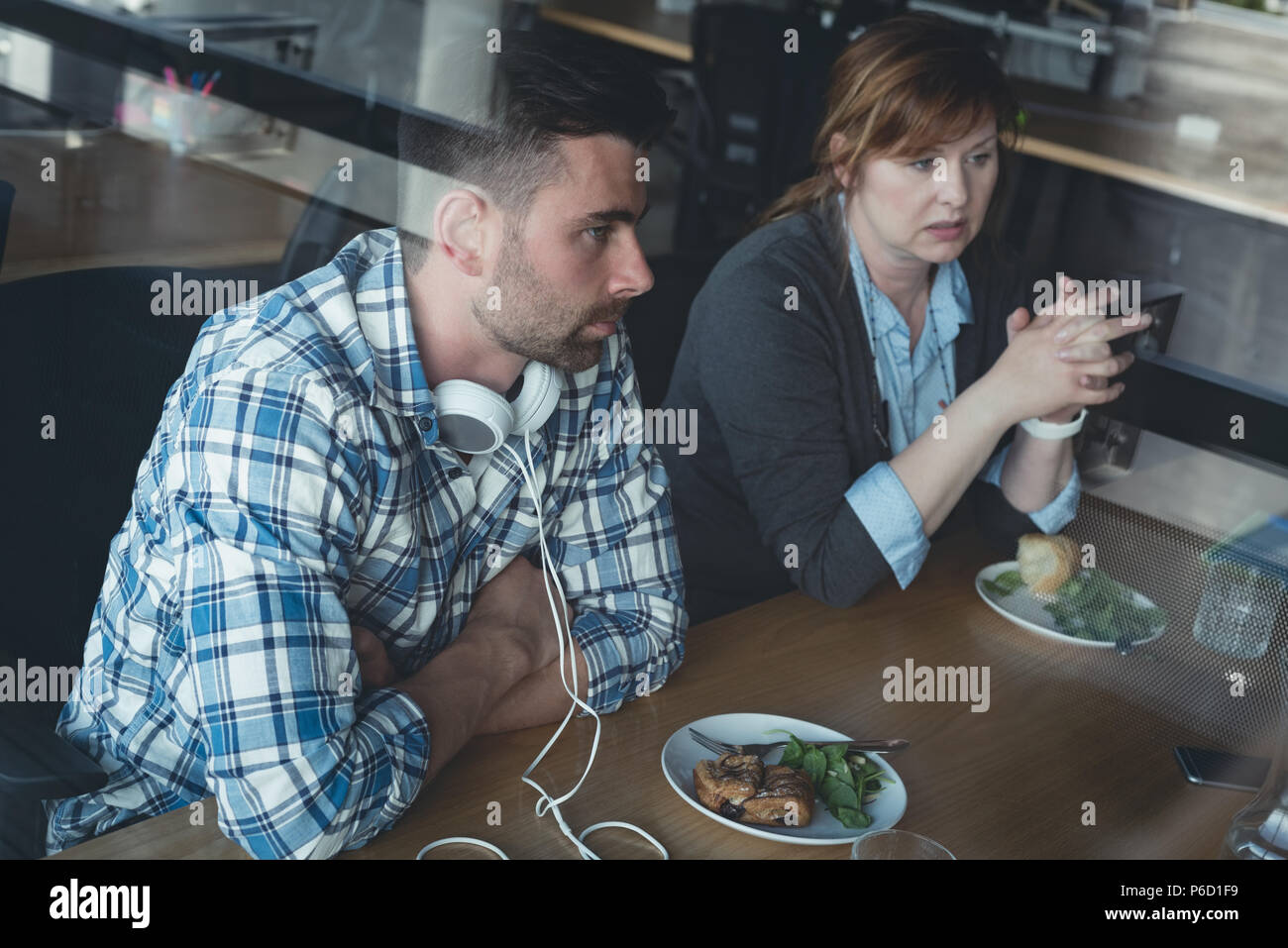 Business colleagues sitting in cafeteria Stock Photo - Alamy