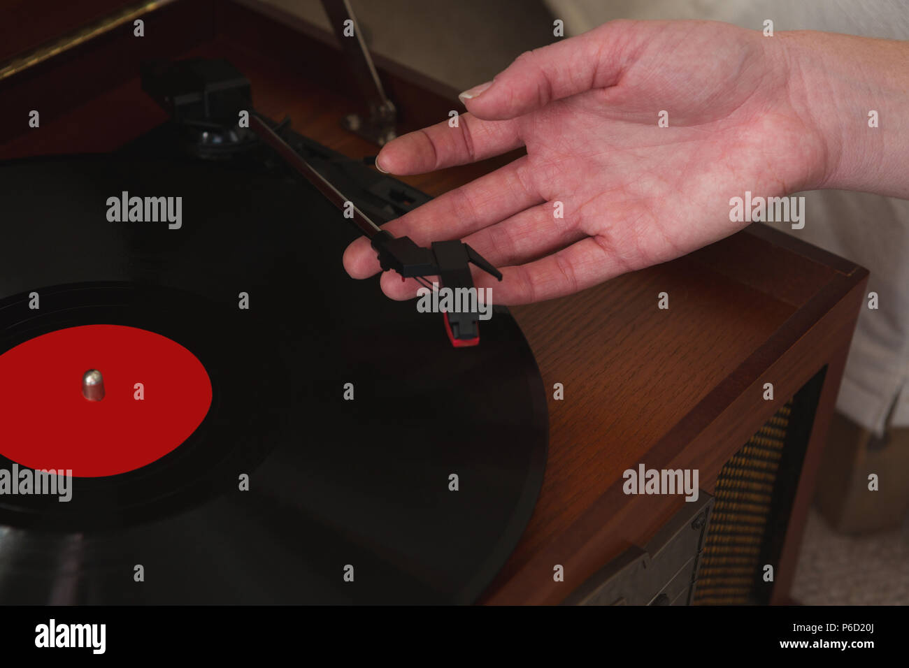 Woman playing a gramophone at home Stock Photo - Alamy