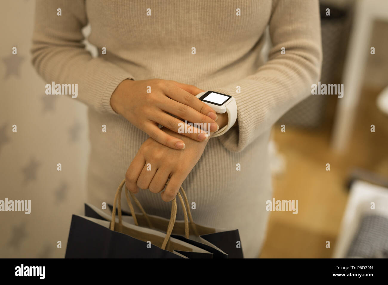 Pregnant woman using smartwatch Stock Photo - Alamy