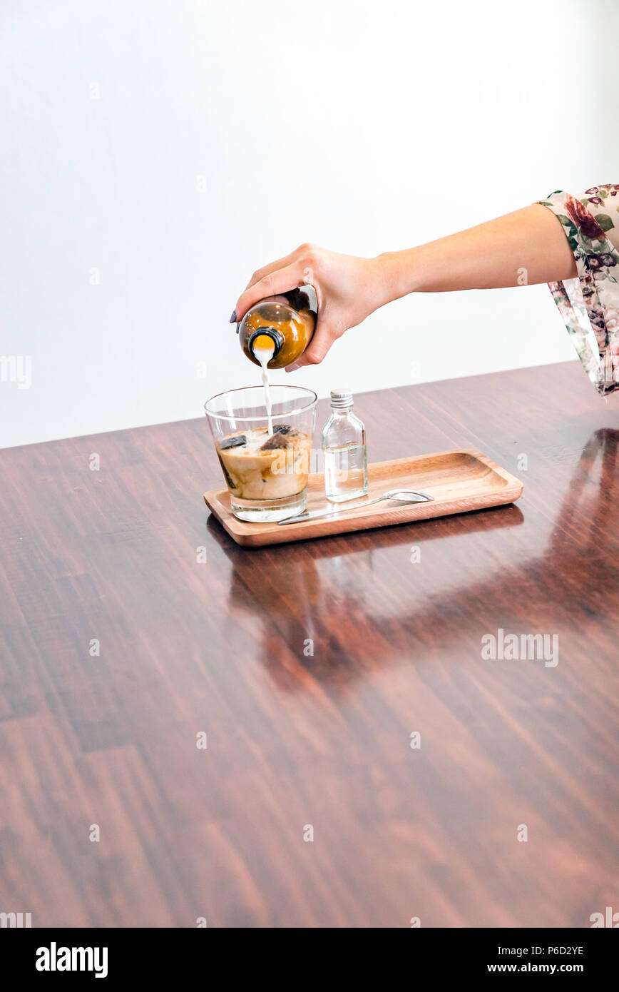 Coffee Cube Latte served with coffe ice cube and milk Stock Photo - Alamy