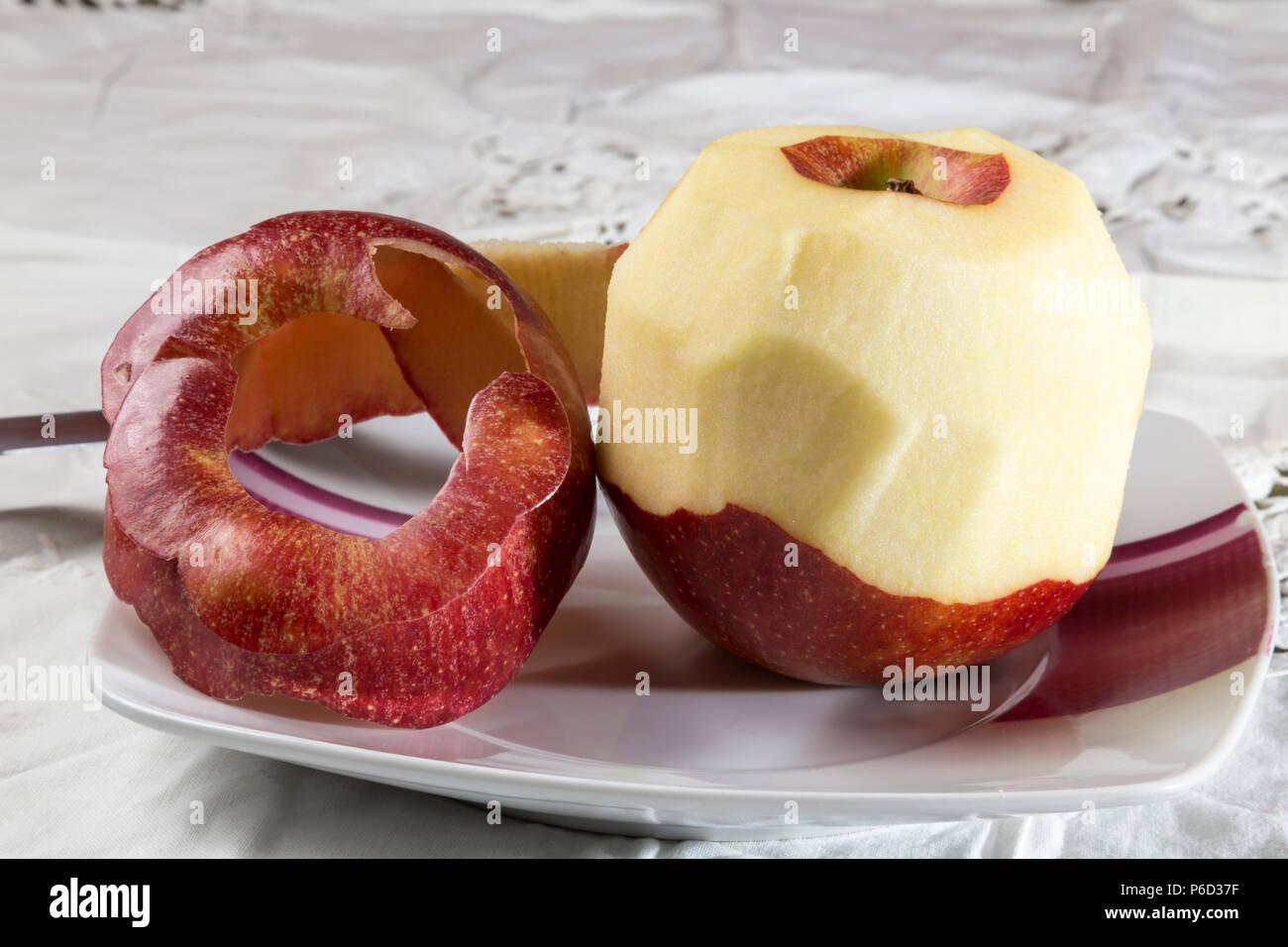 peeled apple with the skin around and put on a plate Stock Photo - Alamy