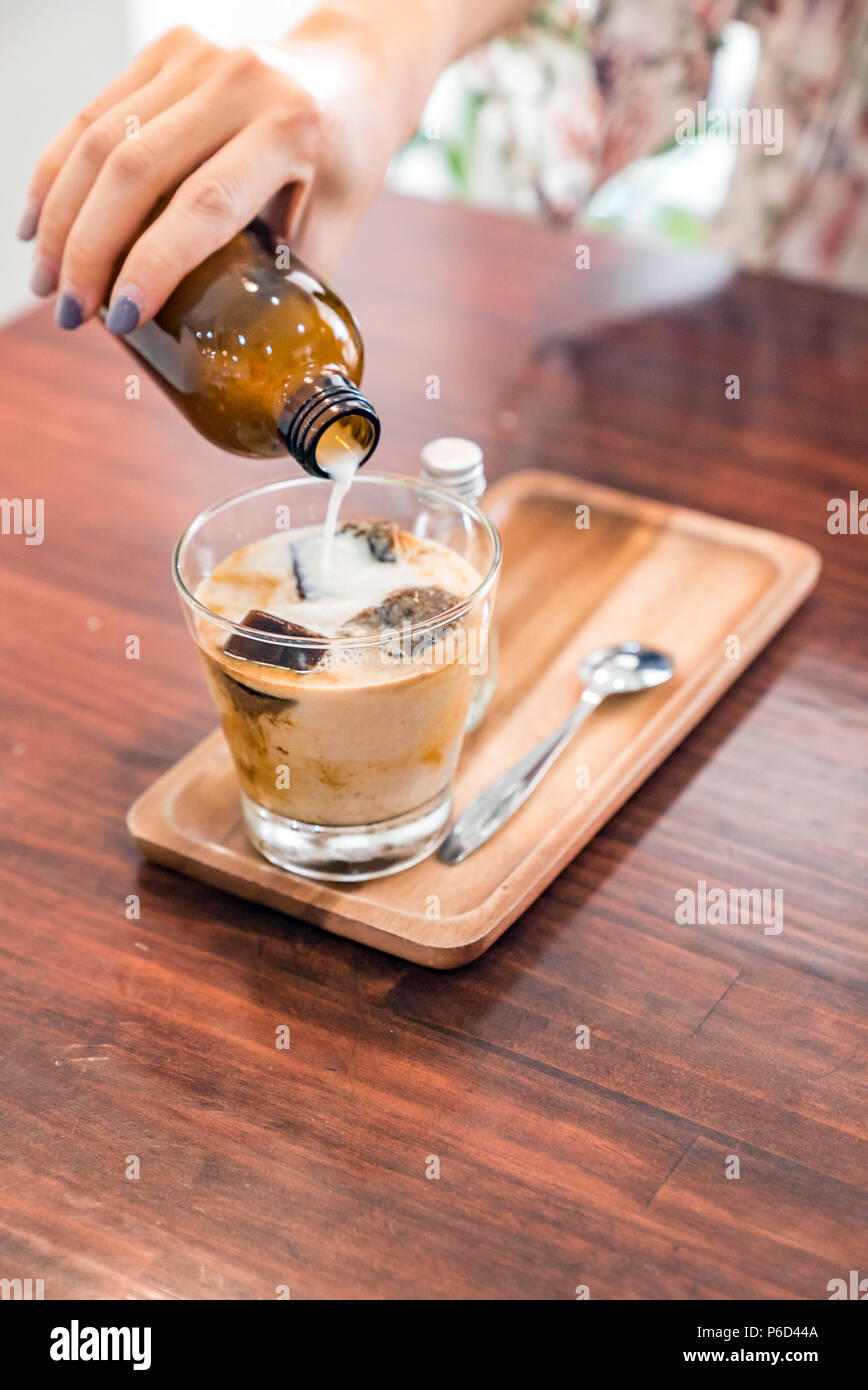 Coffee Cube Latte served with coffe ice cube and milk Stock Photo - Alamy