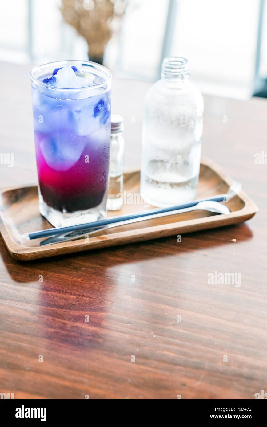 Butterfly pea ice cube server with soda water Stock Photo - Alamy