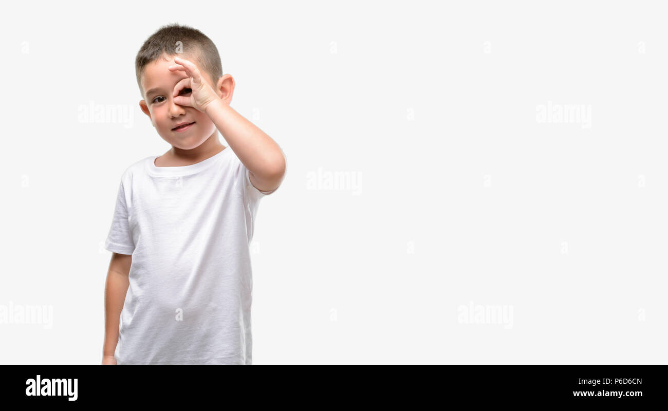 Dark haired little child with happy face smiling doing ok sign with ...