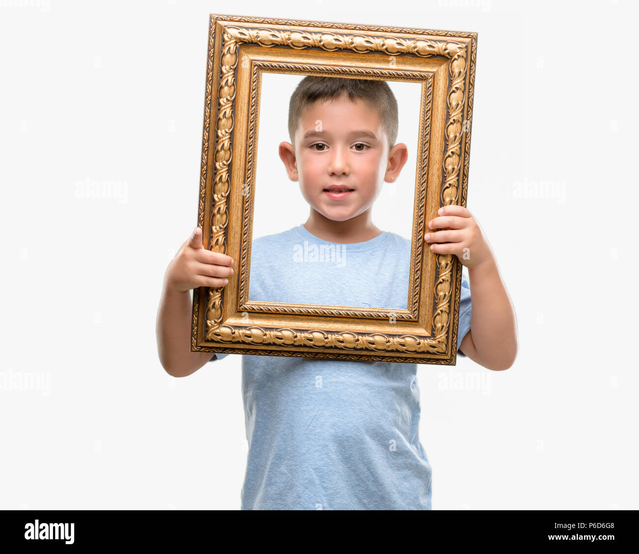 Dark haired little child holding frame pointing with finger to the ...
