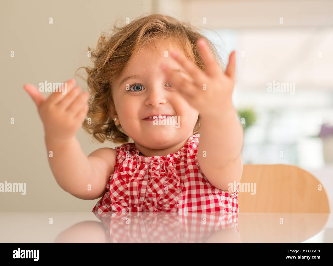 Beautiful blond child smiling asking for hold, wanting attention at ...