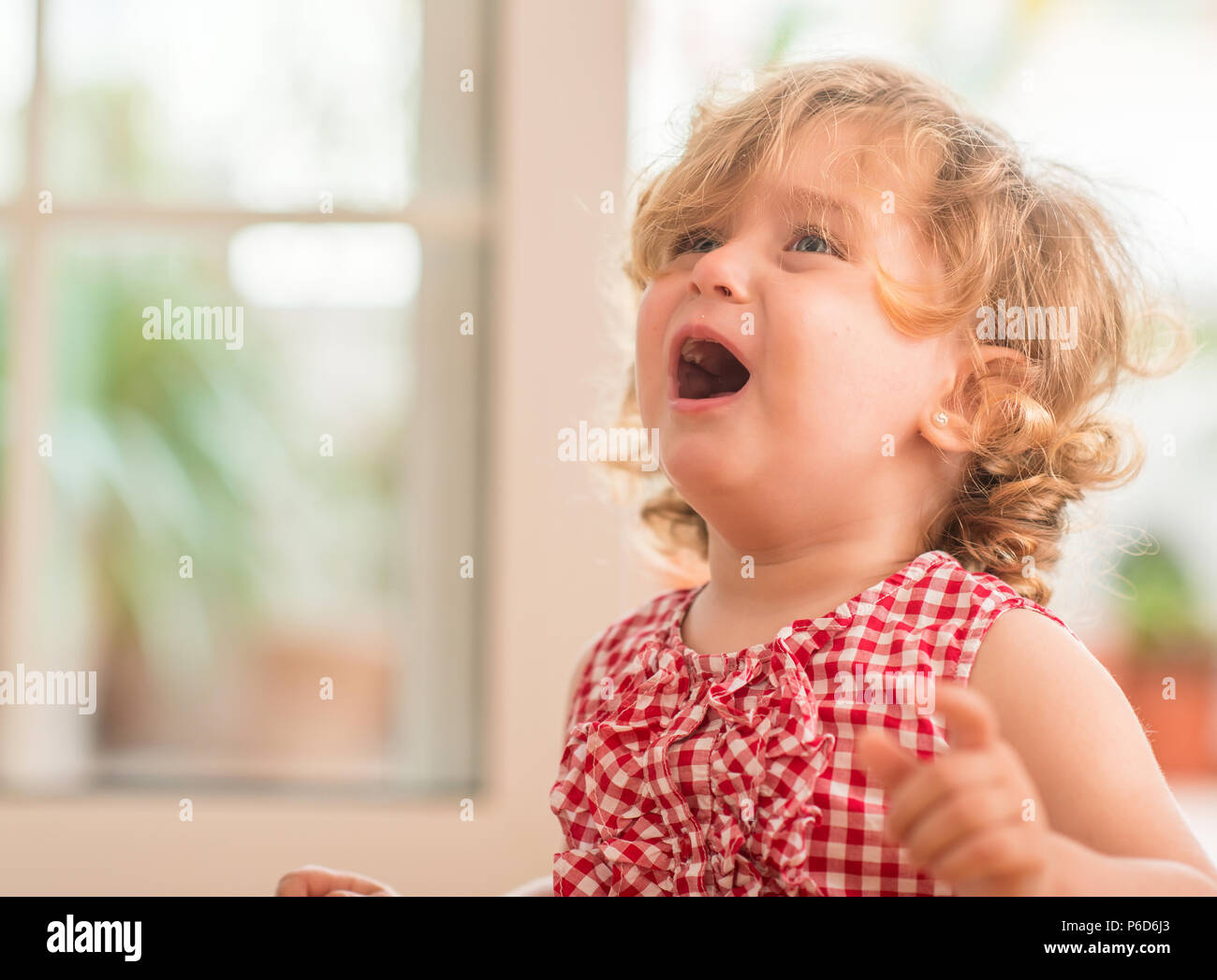 Beautiful blond child crying and shouting with tantrum at home Stock ...