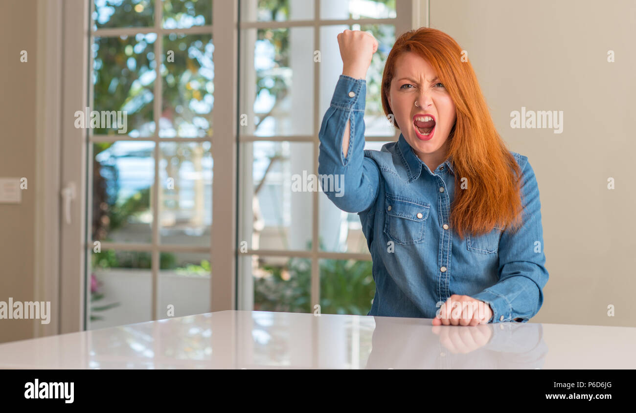Redhead woman at home annoyed and frustrated shouting with anger, crazy ...